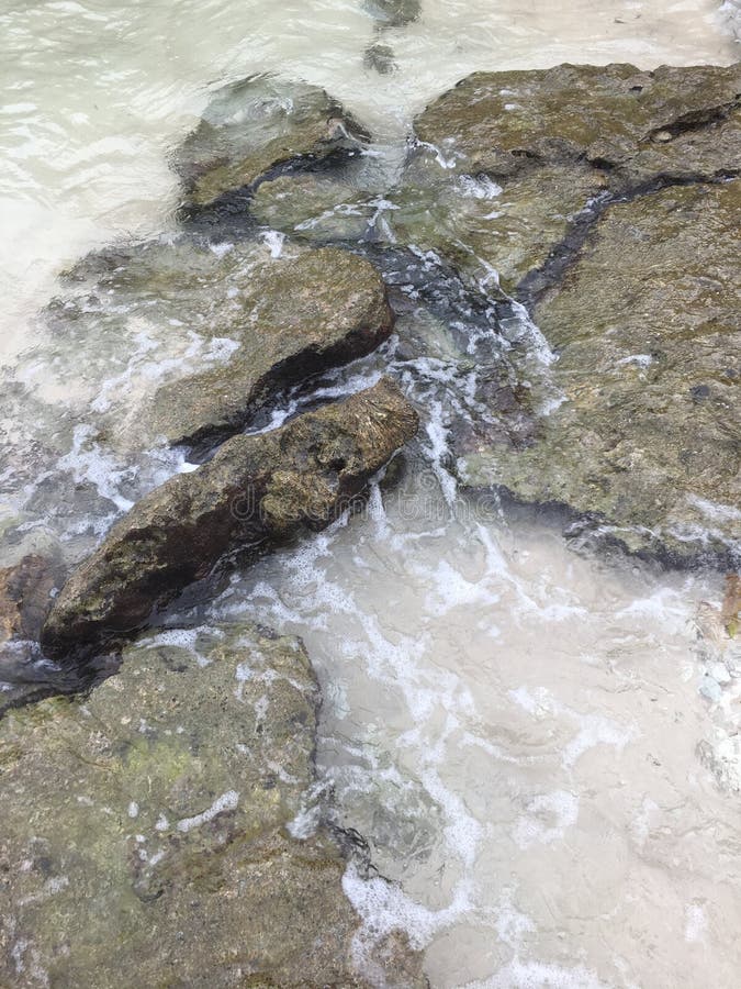 Water flows over the rock stock image. Image of rock - 263870029