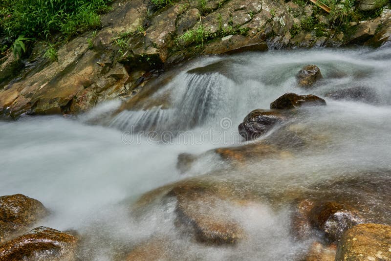 Water Flows Over Rocks in a Little Waterfall. Stock Image - Image of ...