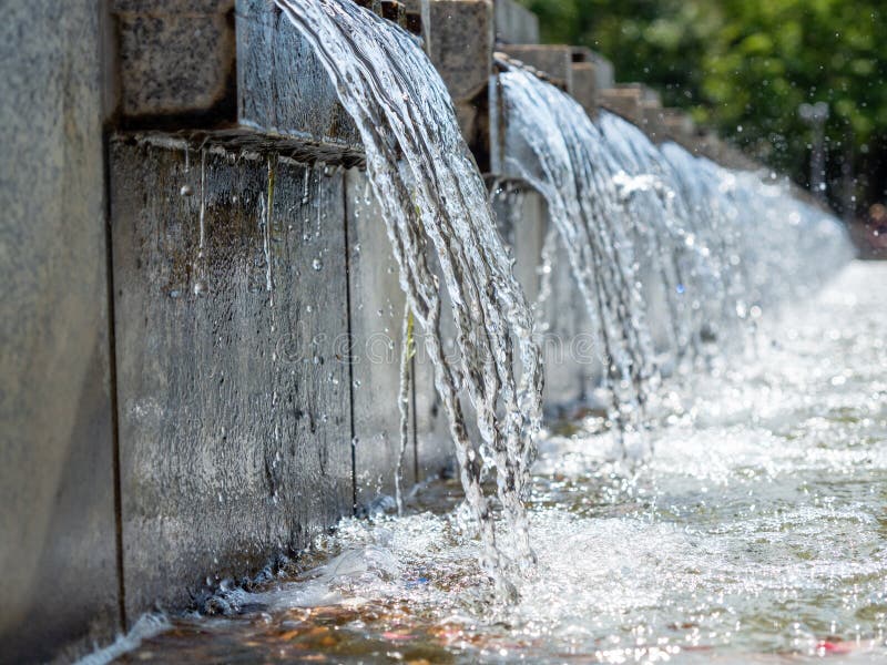 Water Flows Over the Stone Slabs of the City Fountain. Stock Image ...