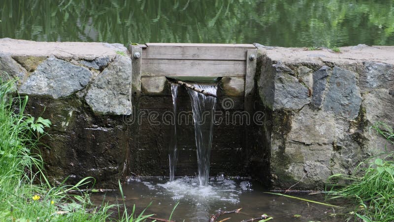 A Water Flows through the Sluices on the Small Stone Dam Stock Video ...