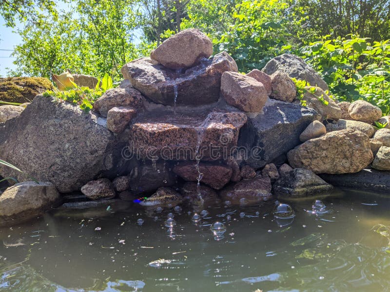 Water Flows through Stones on a Summer Cottage during the Day in the ...