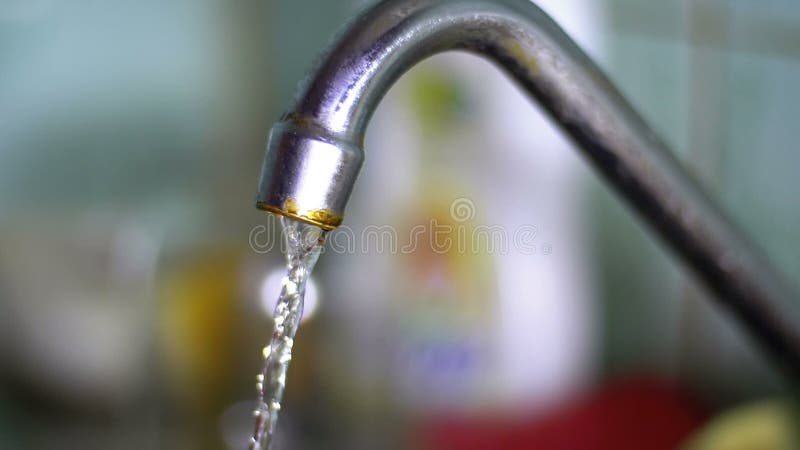 Water Flows From An Old Contaminated Tap With Calcium And Grime Into A
