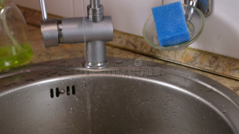 Water Flows in a Thin Stream from the Tap in the Kitchen. Broken Faucet ... Water Flows in a Thin Stream from the Tap in the Kitchen. Broken Faucet ...