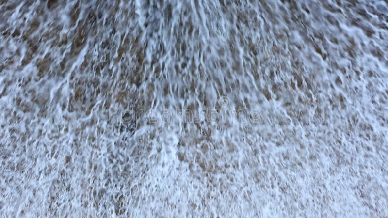 A Water Flows through the Sluices on the Small Stone Dam of the Pond ...