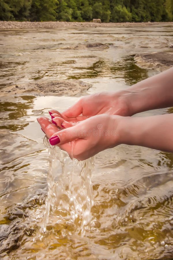 Water Flows through Your Fingers. Hands Gathered Water in the River ...