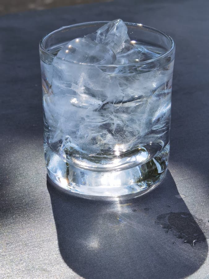 Water on a Glass with Ice Cubes on Black Table Stock Image - Image of ...