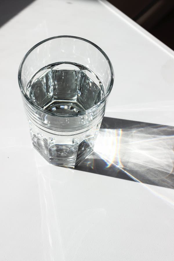 Water Glass With Strong Shadows On White Background Stock Photo - Image ...