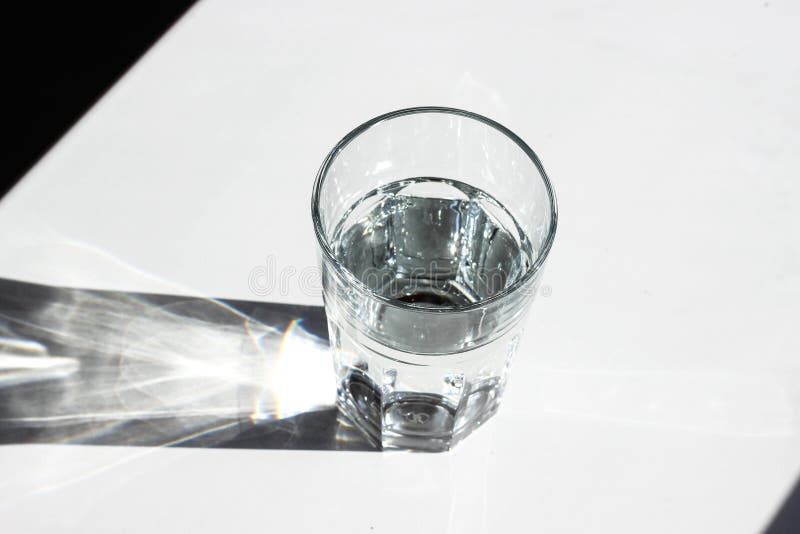 Water Glass with Strong Shadows on White Background Stock Image - Image ...