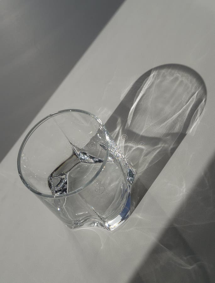 Water Glass with Strong Shadows on a White Background Stock Image ...