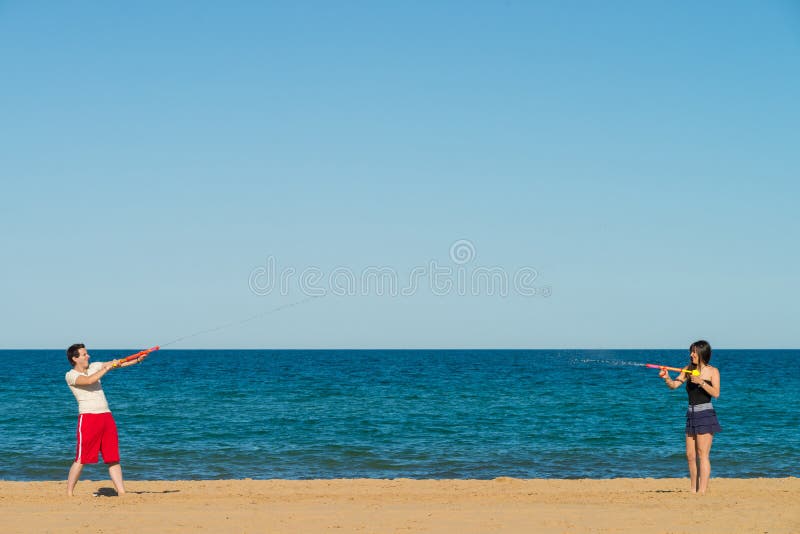 Water Gun Fight on the Beach Stock Image - Image of playful, squirt ...