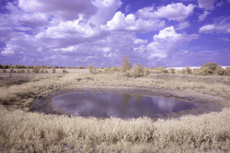 Water Hole Under a Cloudy Blue Sky Stock Image - Image of dried ...