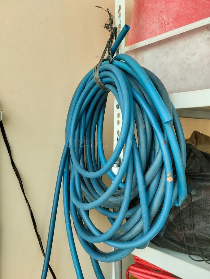 The Water Hose is Rolled Up on the Rack Stock Photo - Image of water ...