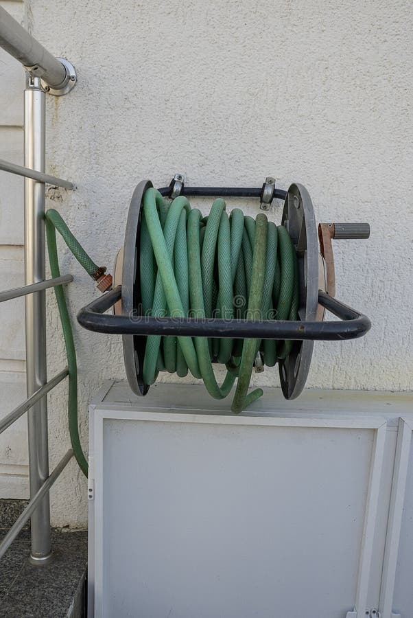 Water hoses on the wall stock photo. Image of gardening - 386104916