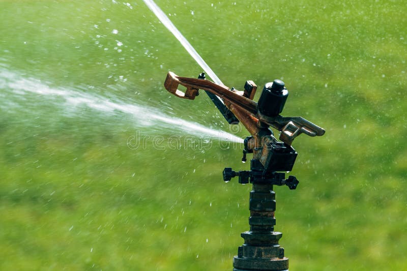 Water Irrigation Impact Sprinkler in Operation in Field Stock Photo ...