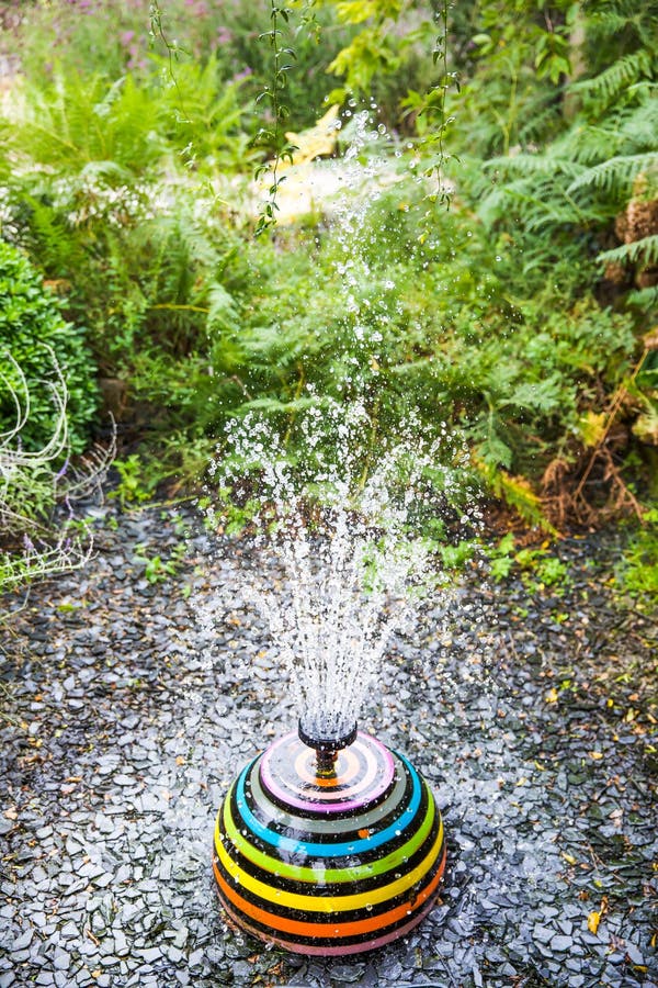 Water Jets in Multi-colored Ceramic Vases in Green Martels Garden Stock ...
