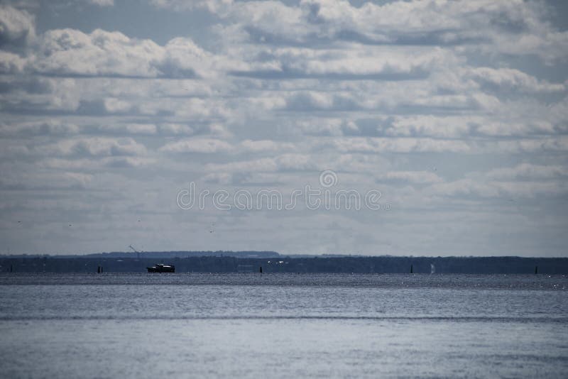 A Water Landscape with Clouds and a Ship in the Distance Stock Image ...
