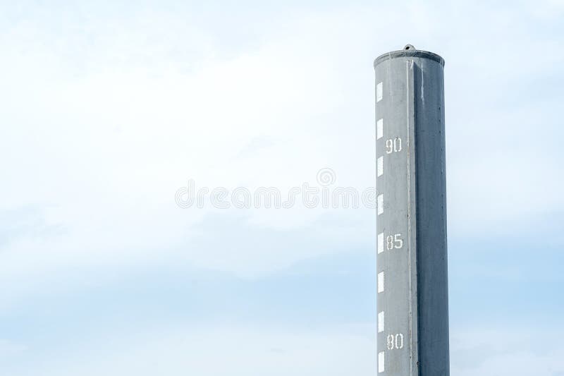 Water Level Gauge Indicating the Waters Depth at a Harbor Against a ...