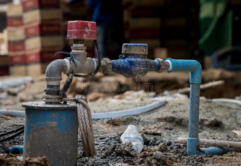 A Water Meter is Securely Attached To a Pipe that is Embedded in the ...