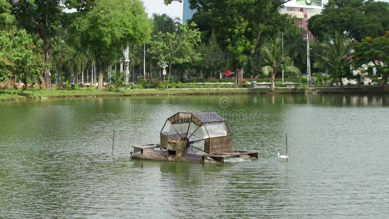 Water Mill for Filtering Water in the Park Lake Stock Footage - Video ...