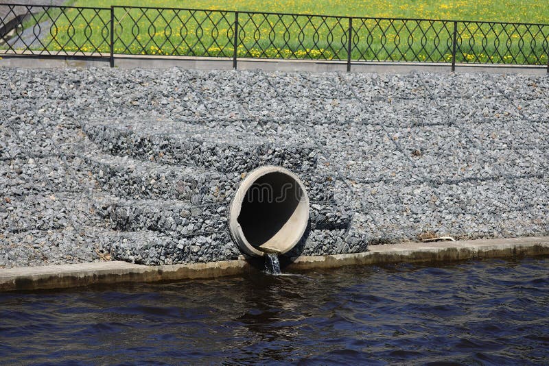 Water Outflows in the River through Flood Drainage System. Stock Photo ...