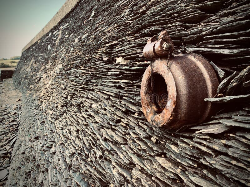 Water outlet in slate wall stock photo. Image of built - 207874360