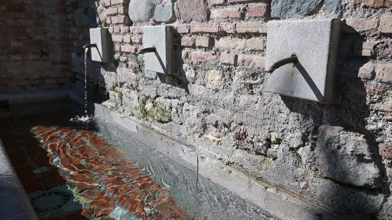 Water Outlets in Stone Wall Flow into Basin Under Sunlight Stock Video ...