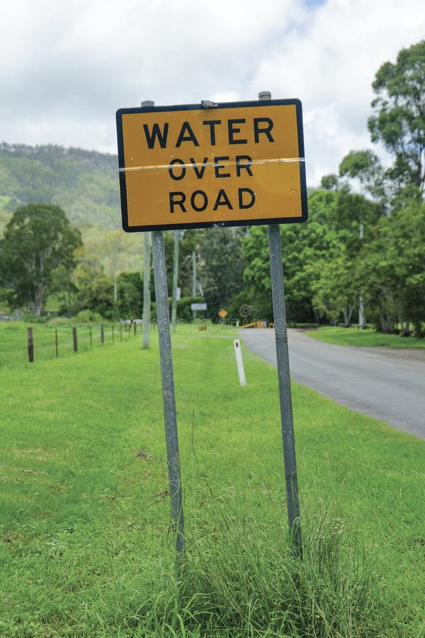 Water over road sign stock image. Image of heavy, bitumen - 195304455