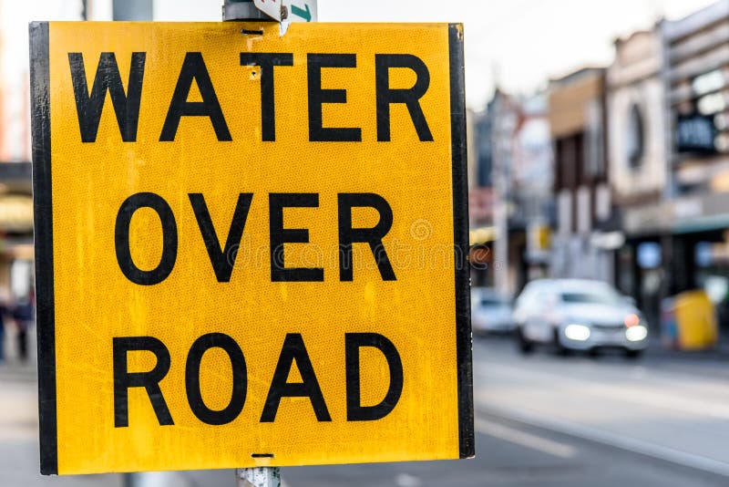 A Road Sign Featuring the Message `Water Over Road` Stock Image - Image ...