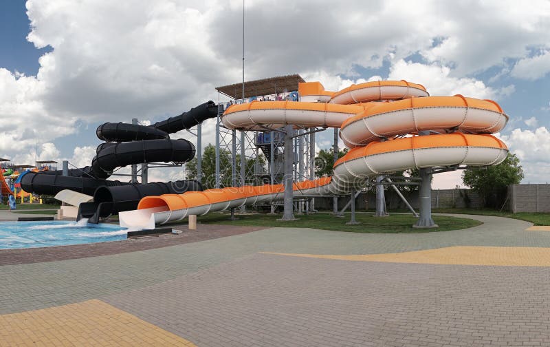 Water Park, Bright Multi-colored Slides with a Pool Stock Photo - Image ...