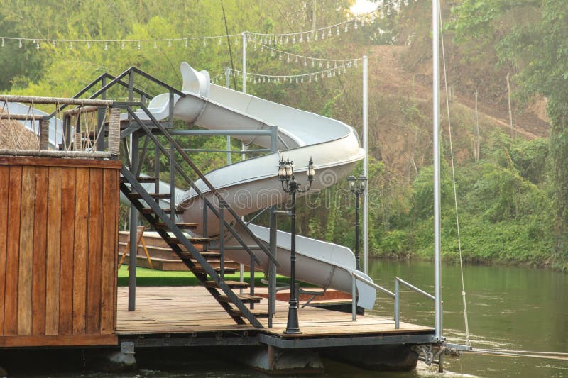 The Water Park Slide Goes into the River Stock Image - Image of holiday ...