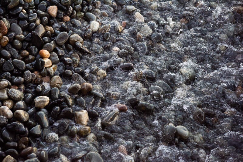 Water on a pebble beach stock photo. Image of liquid - 168748084