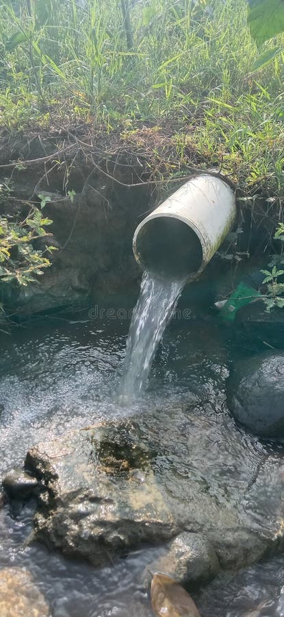 A Water Pipe Releases Water so that it Forms a Pond Stock Image - Image ...