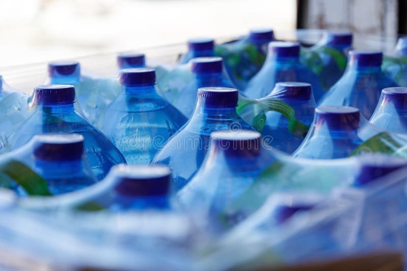 Water in Plastic Bottles Packed with Plastic Wrap. Shallow Depth of ...