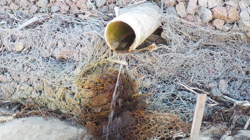Water Pollution in the Canal. the Flow of Water Spilling from the Pipe ...