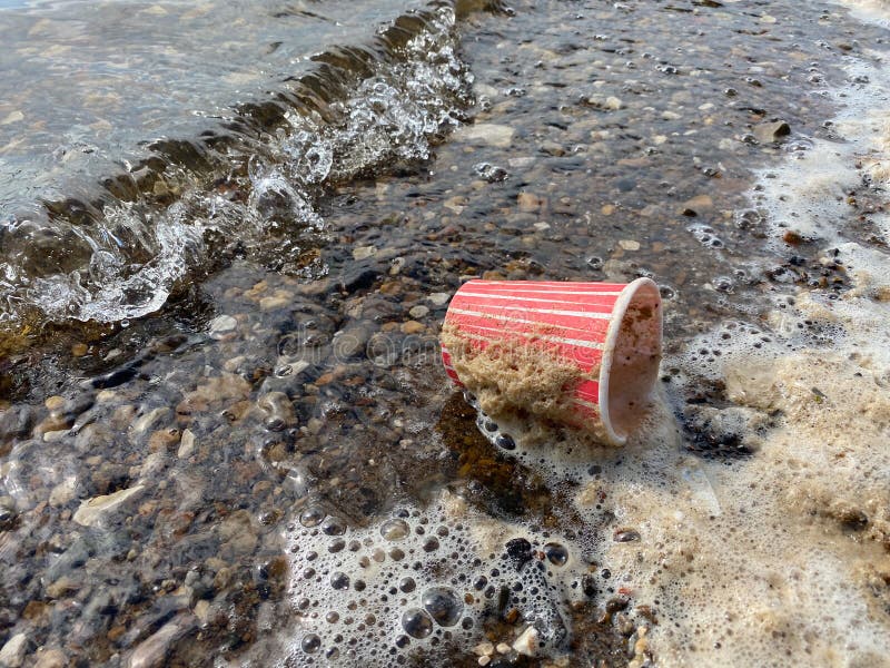 Water Pollution. Foam on Water Surface and Paper Coffee Cup. Closeup ...