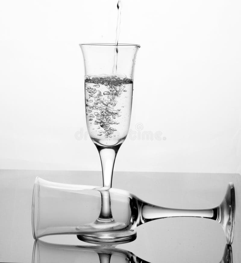 Water is Poured into a Glass on a Glass Table with Reflection Stock ...