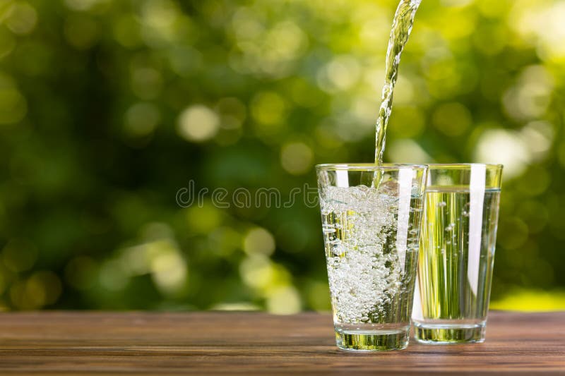 Water Pouring into Glass on Table Outdoors Stock Photo - Image of ...