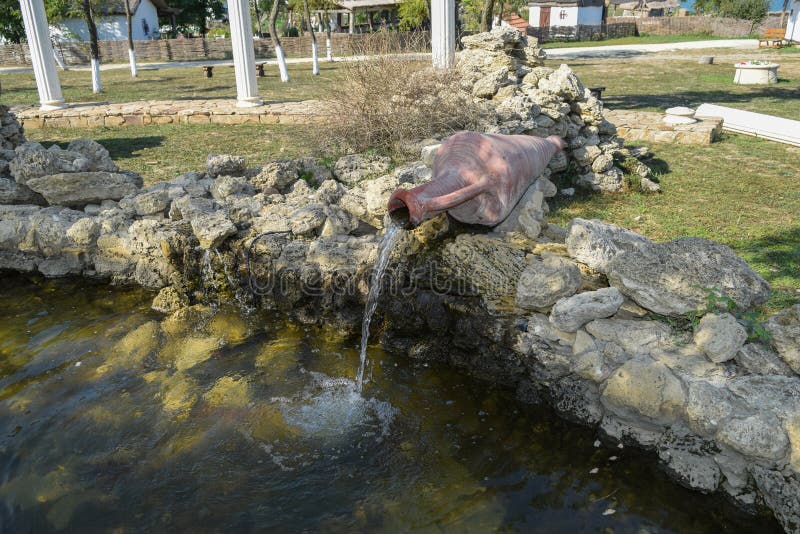 Water Pouring from a Jug into a Pond Stock Photo - Image of artificial ...