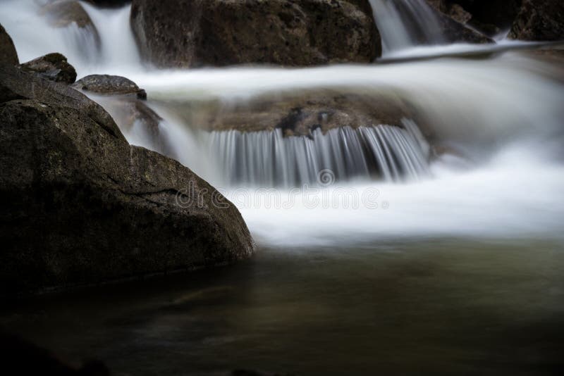 Water pouring over a rock stock image. Image of soft - 69284667