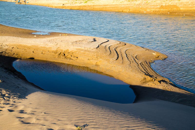 The wet sand and puddles stock photo. Image of boulder - 14732792