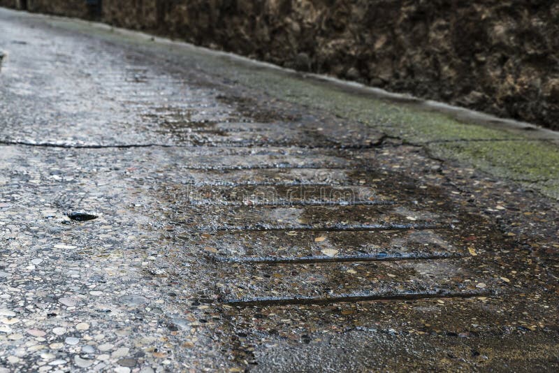 Water Rain Puddle On An Old Cobble Stone Street Stock Photo - Image of ...