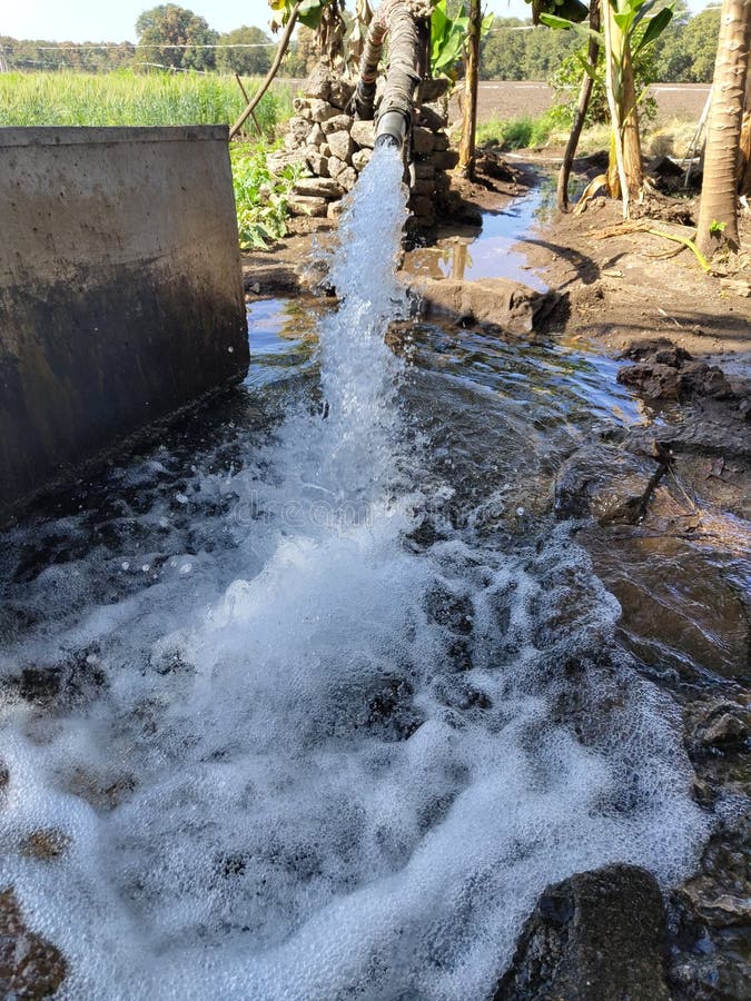 Water pump spewing water stock photo. Image of geology - 267591258