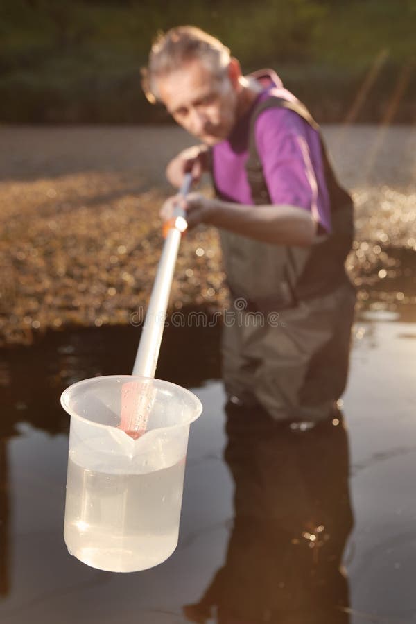 Analyst in Chest Waders Bootfoot Collecting Samples of Water Stock ...