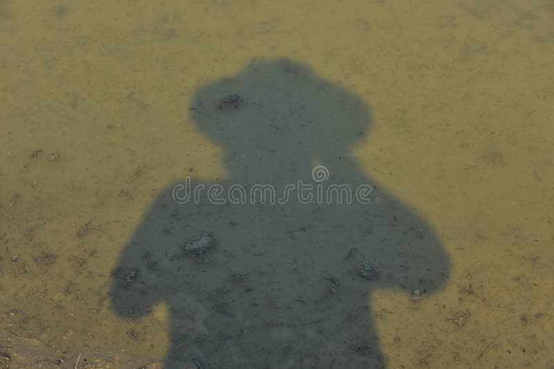 Water Reflection in the Form of a Person Wearing a Hat on the Water ...