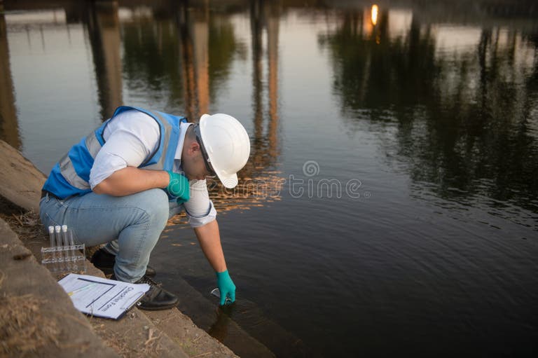 A Water Resource Worker is Collecting Water Samples in a Large ...
