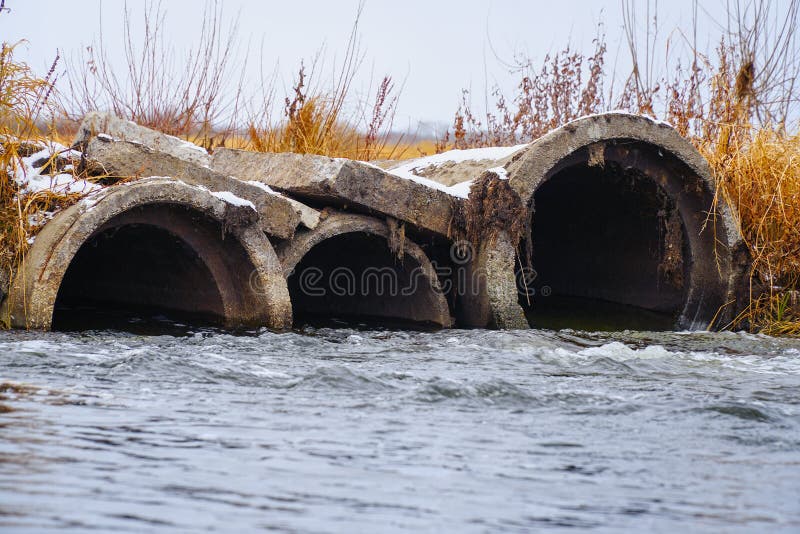 The Water on the River Flows from Large Pipes. Dam on River Stock Image ...
