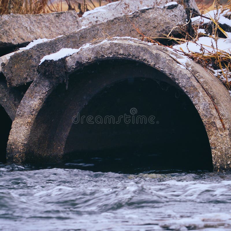 The Water on the River Flows from Large Pipes. Dam on River Stock Image ...