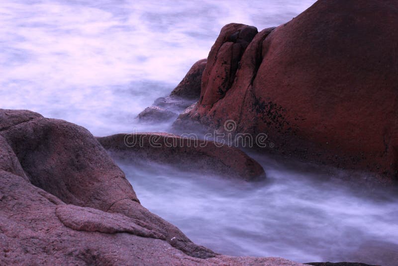Long Exposure of Water between Rocks on the Ocean Stock Image - Image ...