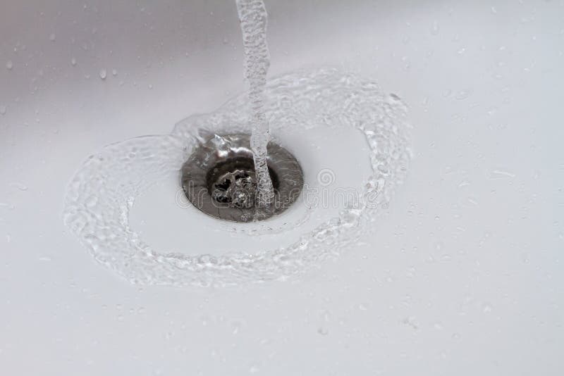 Water Running into Sink Drain Closeup. Drop of Water Falling in Slow ...