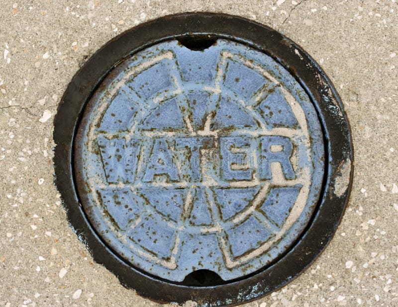 Utilities: Water Main Cover Stock Photo - Image of manhole, street ...